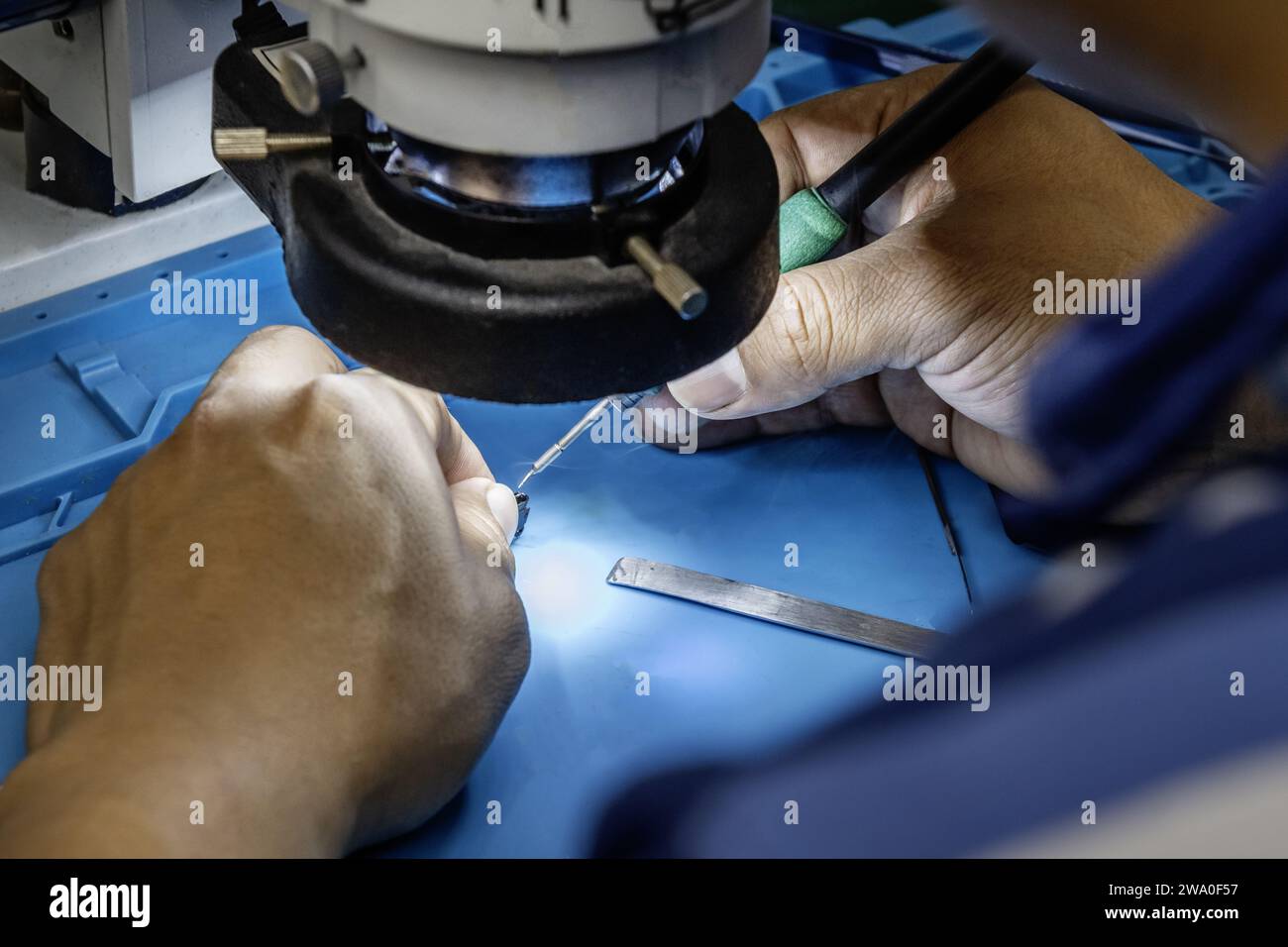 Image of a repair technician in an electronics store working at his ...
