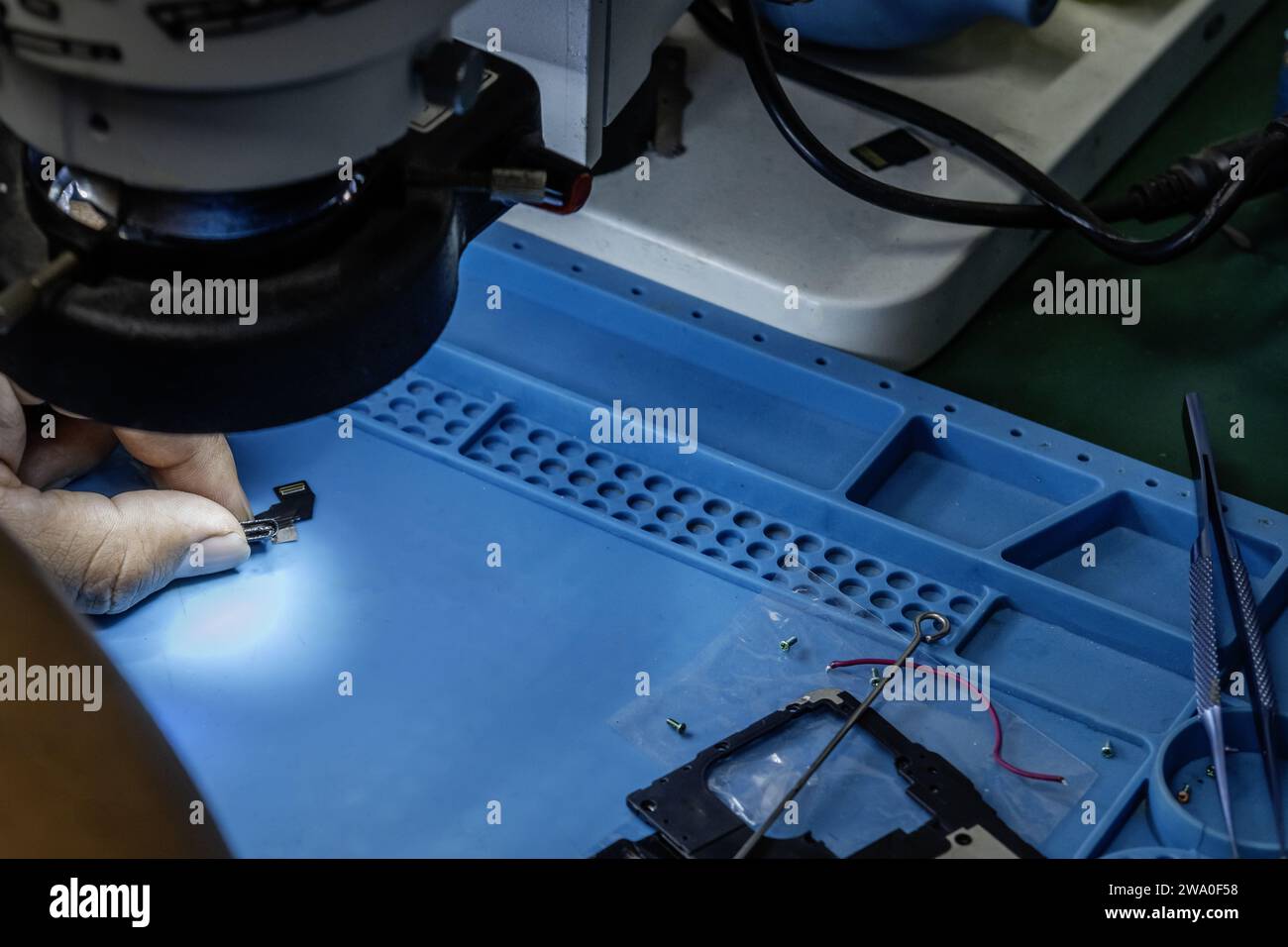 Image of a repair technician in an electronics store working at his ...