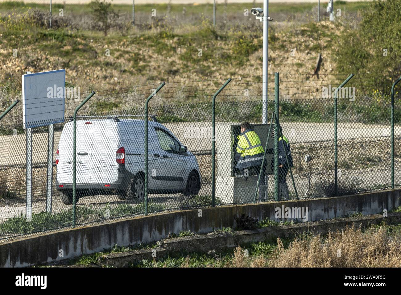 Some maintenance technicians checking an access point to electrical ...