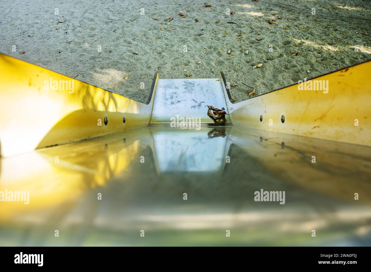 Polished metal ramp leading down a slide in a playground Stock Photo ...