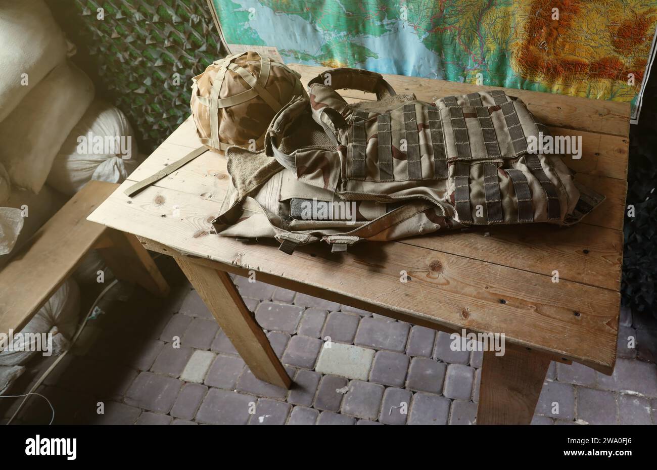 A military helmet of a Ukrainian soldier with a heavy bulletproof vest ...