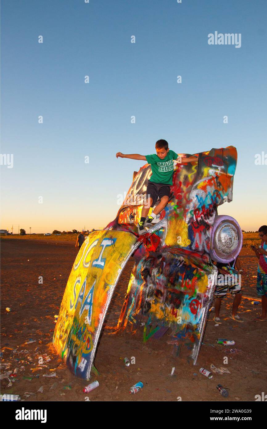 evening sunset boy climbing playing over famous spray painted american ...