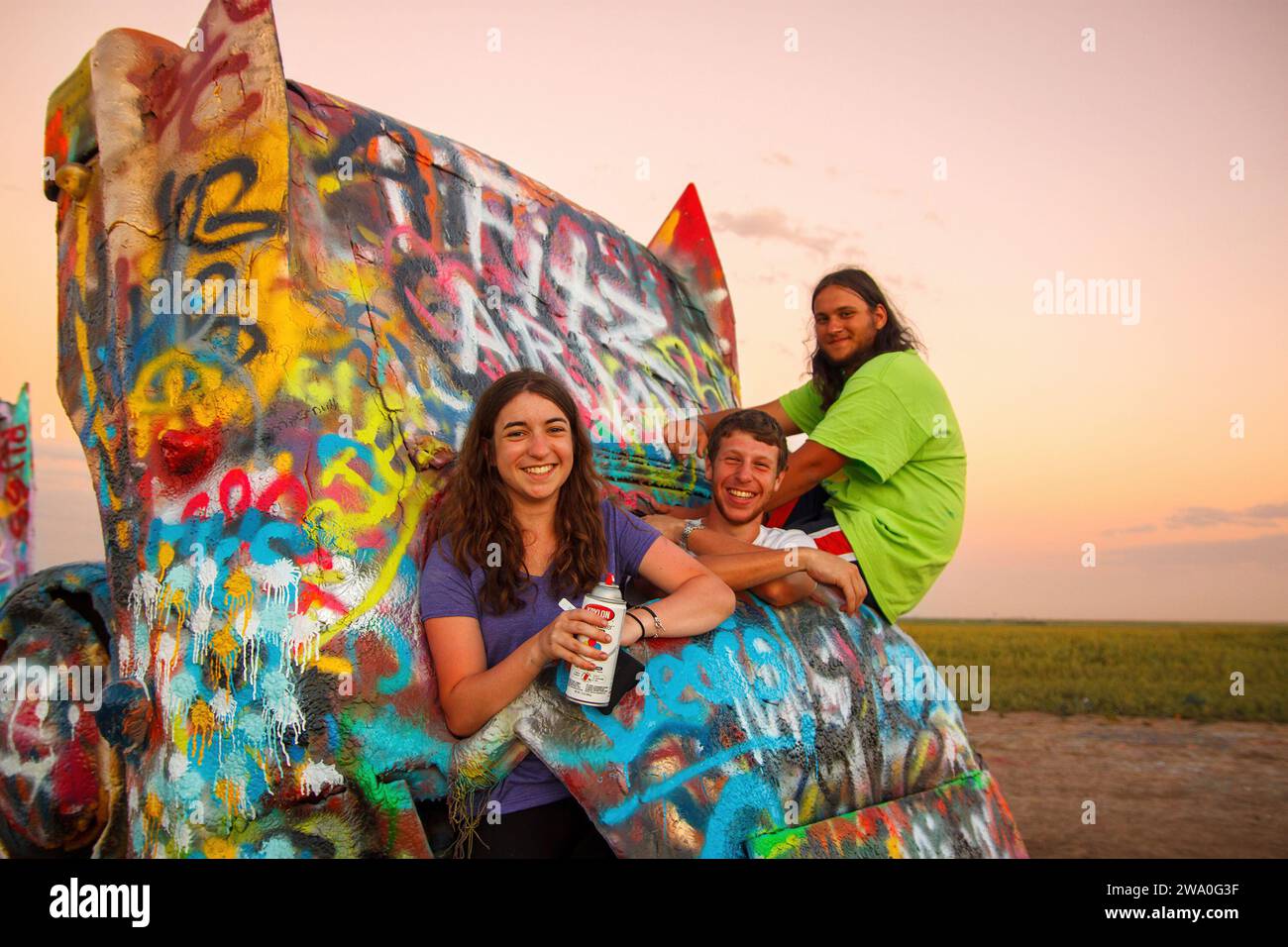 three teenagers sunset posing famous spray painted american cars of ...