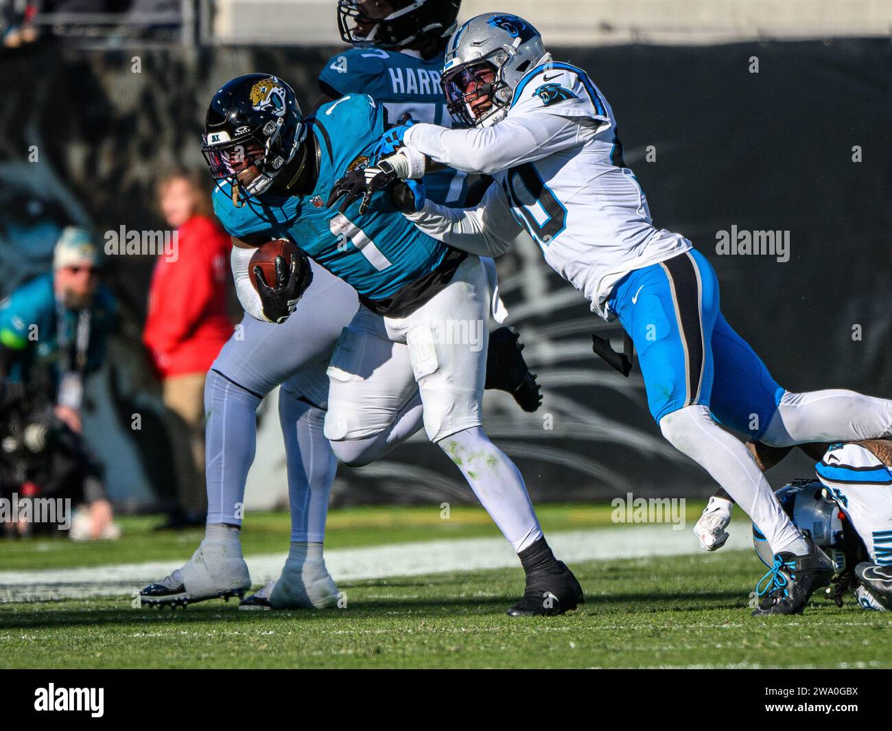 December 31, 2023: Jacksonville Jaguars running back Travis Etienne Jr. (1) is tackled by ...