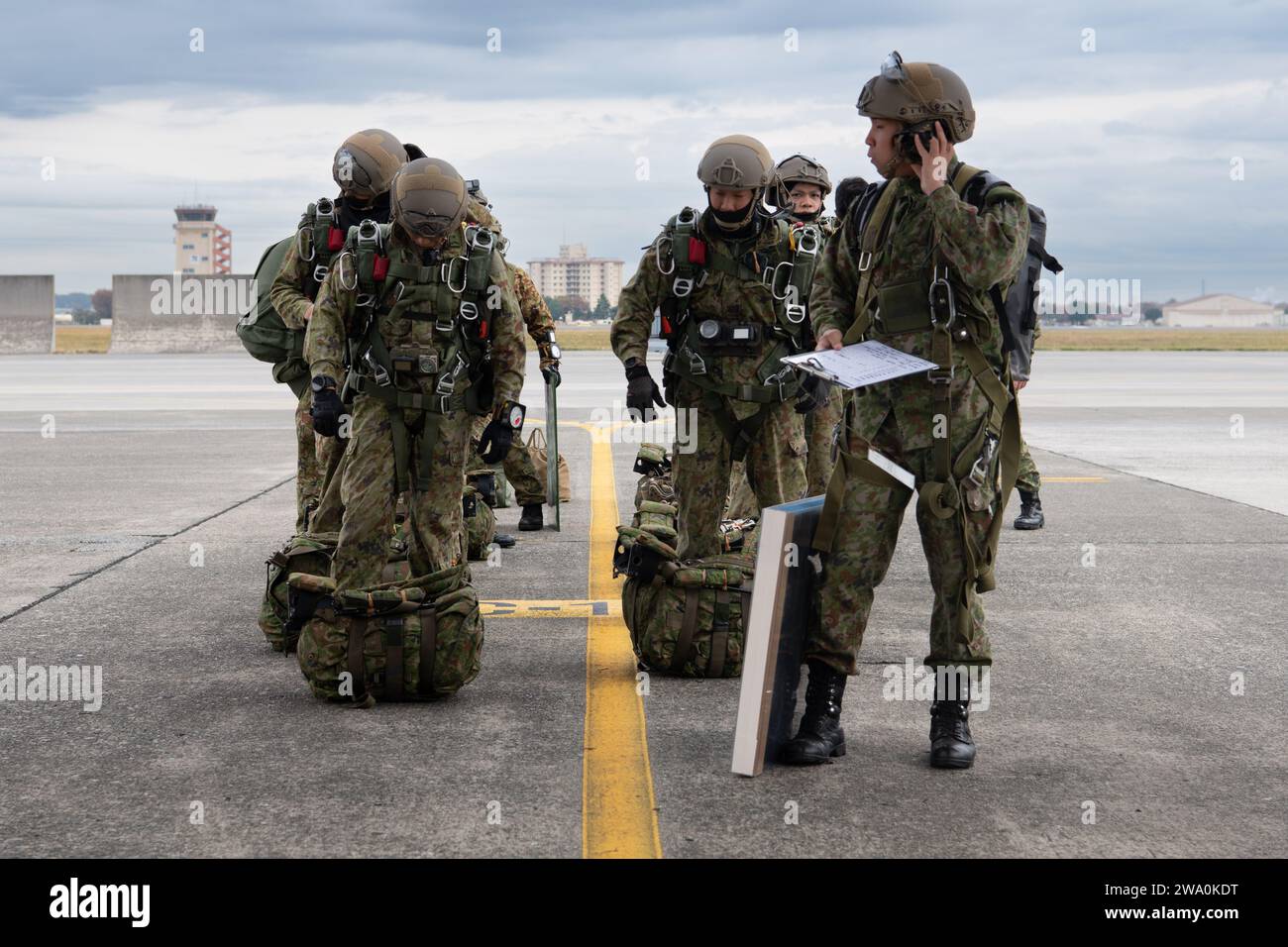 Members of the Japan Air Self-Defense Force (JASDF) don parachutes ...