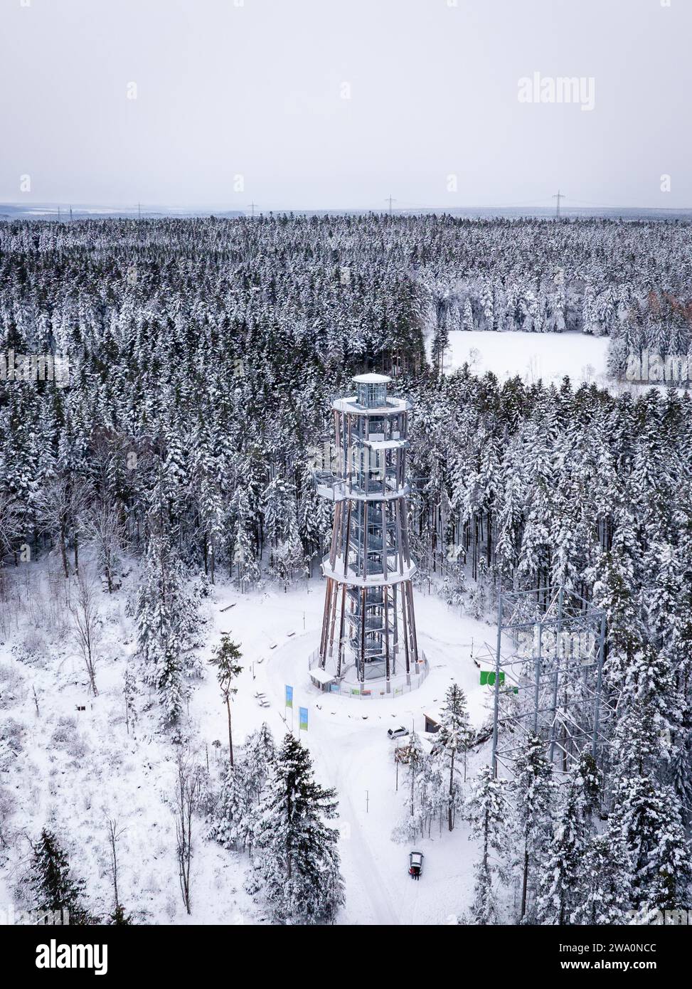 Viewing tower in the middle of a snow-covered forest, aerial view ...