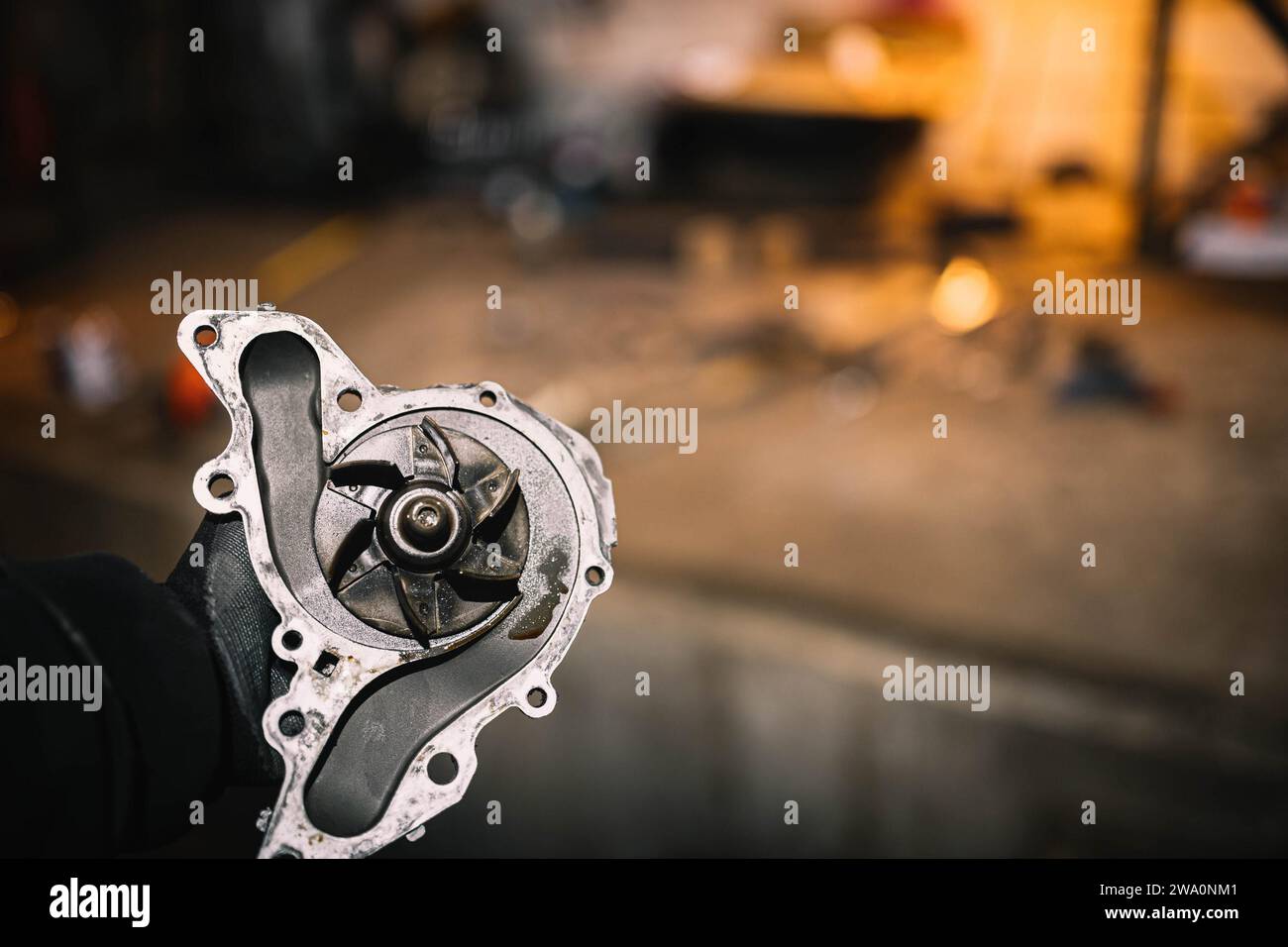 Automotive water pump of the engine cooling system in the hands of an ...