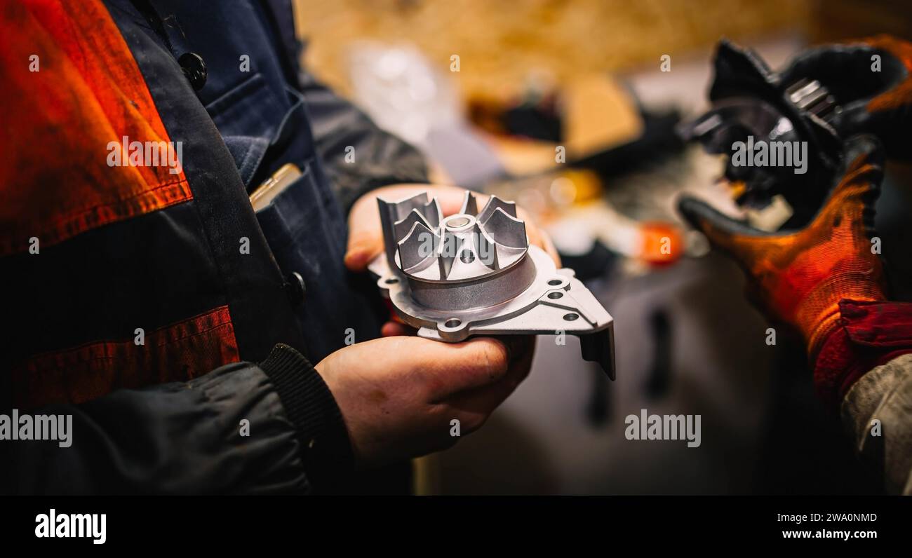 Automotive water pump of the engine cooling system in the hands of an ...