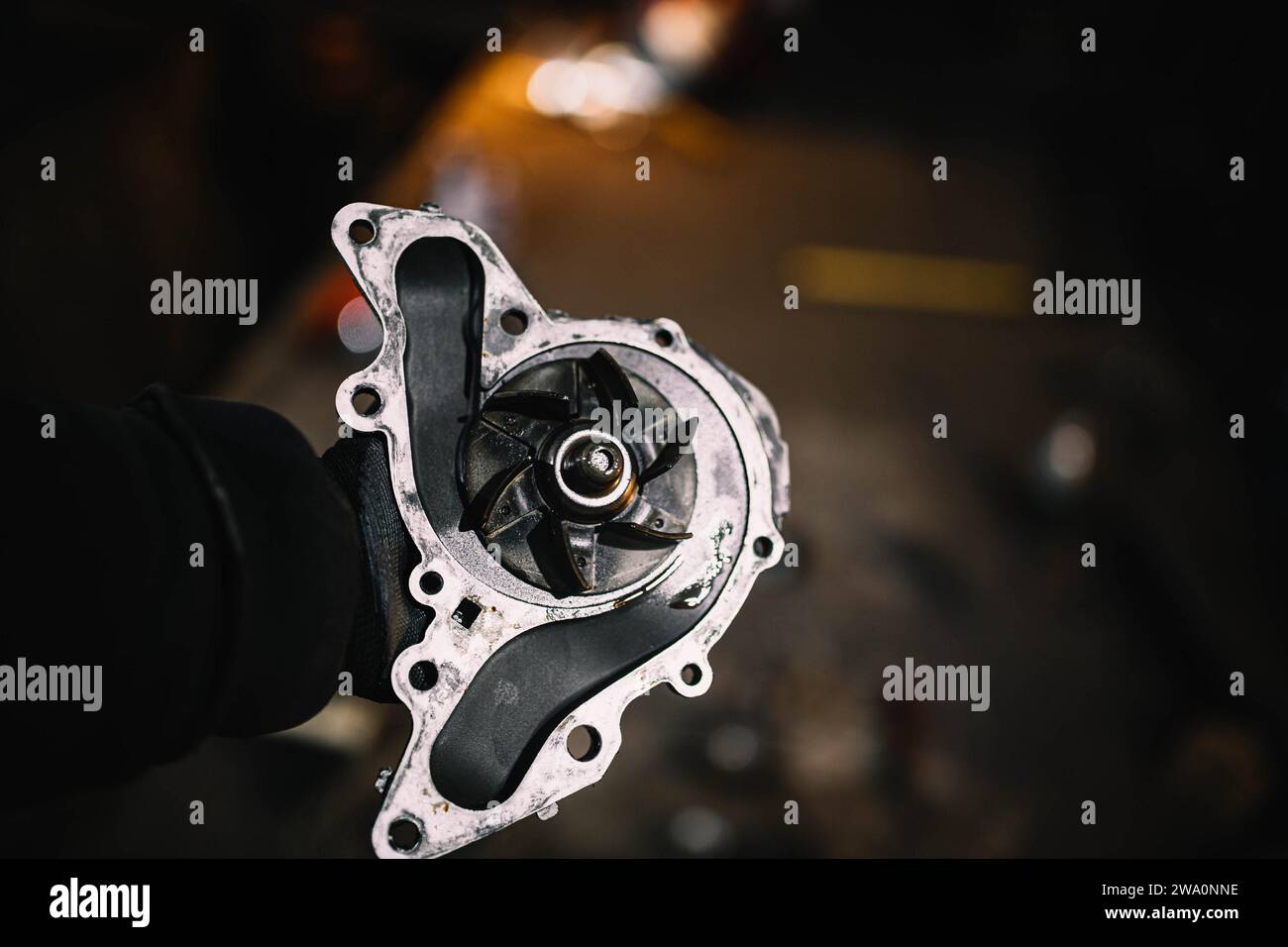Automotive water pump of the engine cooling system in the hands of an ...