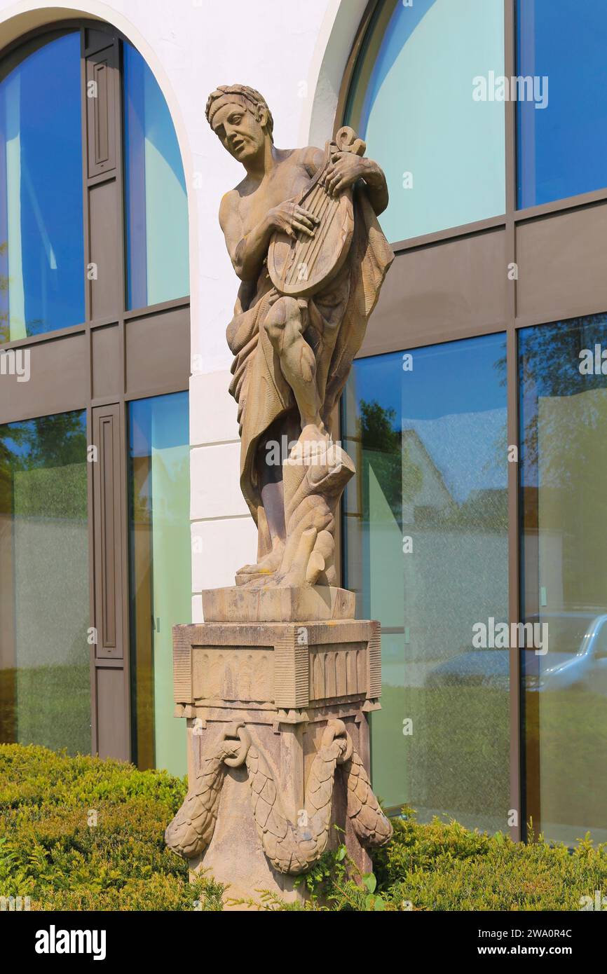 Sculpture with musical instrument, stone figure, male statue in front ...