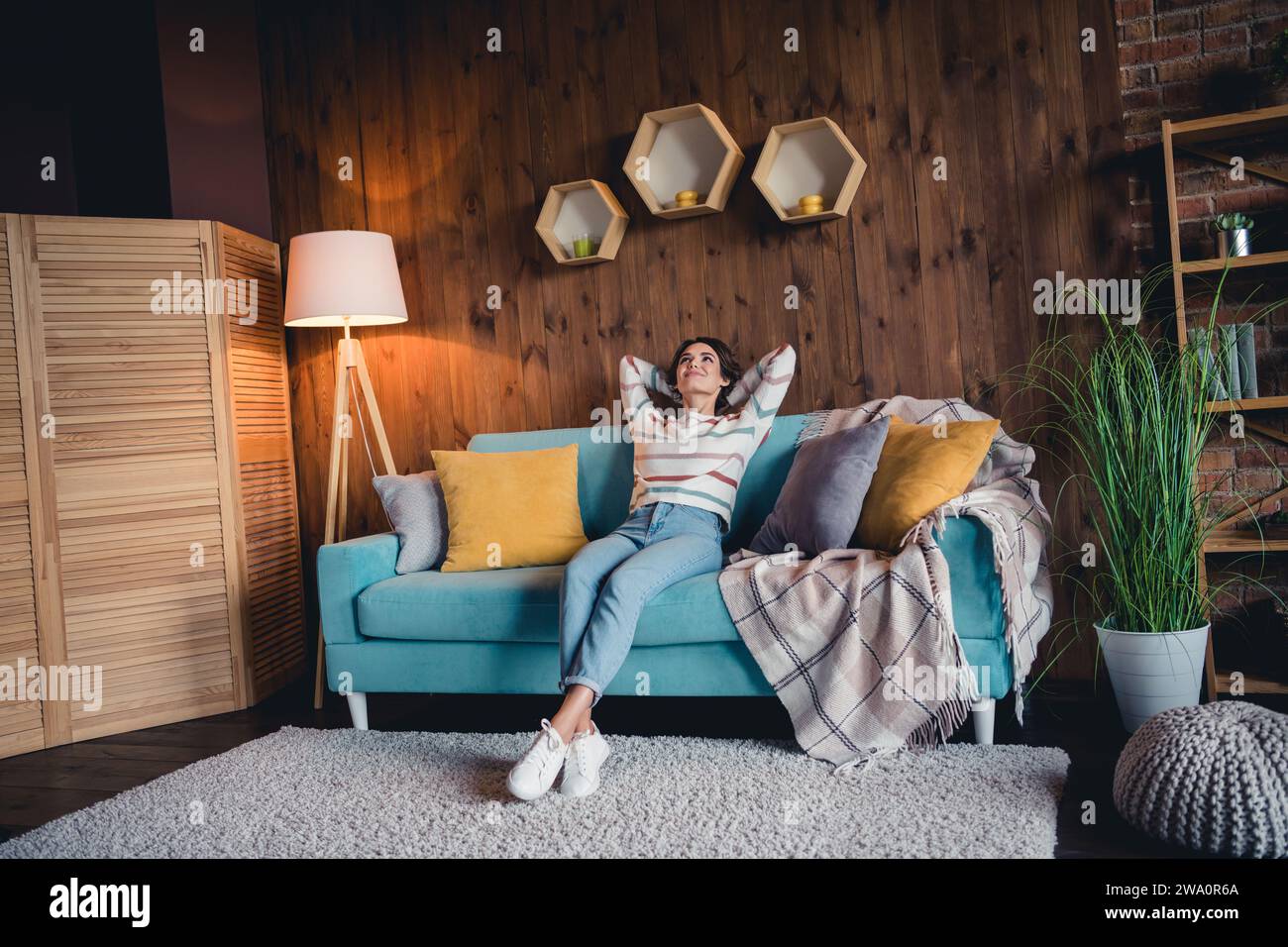 Full body photo of creative gorgeous lady sit cozy couch hands behind ...
