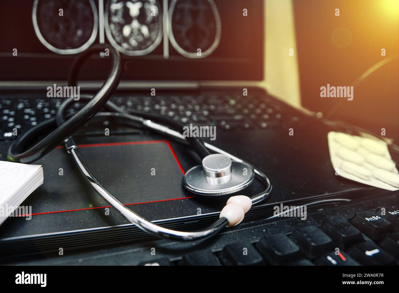 Doctor's desk: stethoscope, laptop Stock Photo - Alamy