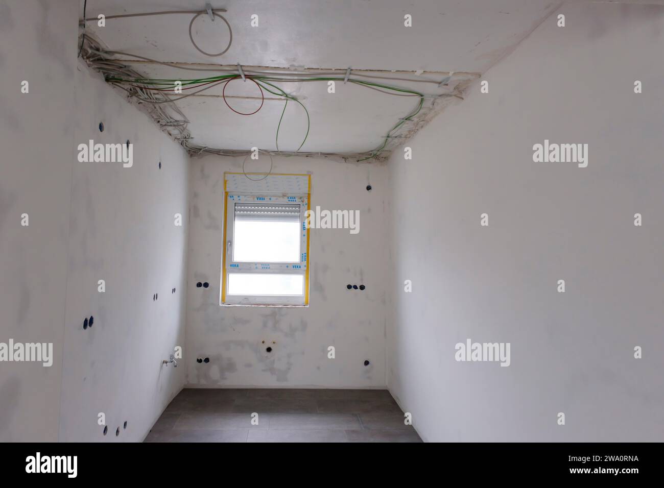 Room with newly laid electrical cables under the ceiling, Fresh plaster ...