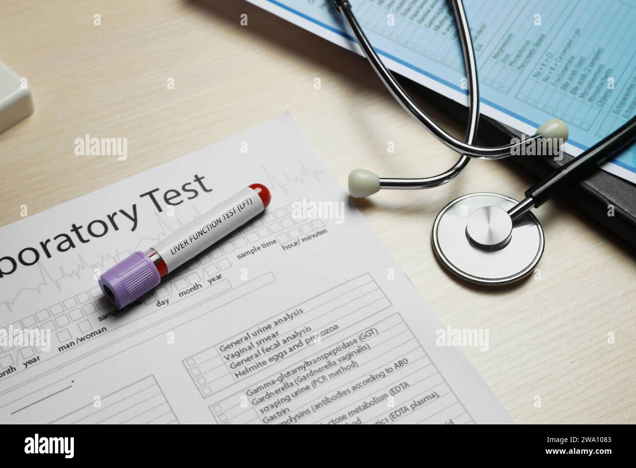 Liver Function Test. Tube with blood sample, stethoscope and laboratory ...