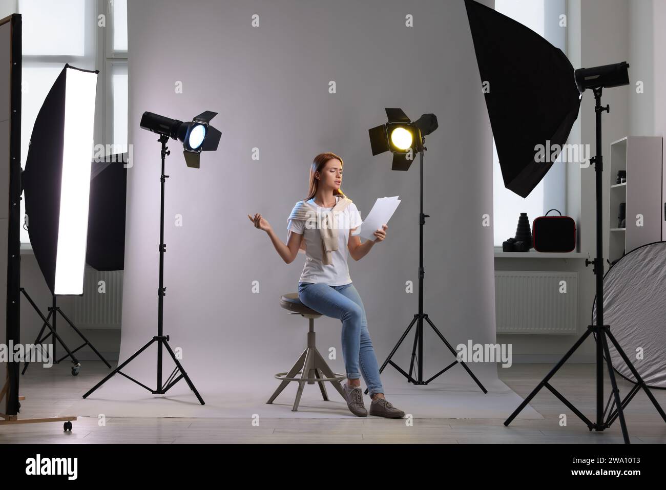 Casting call. Emotional woman with script performing on grey background ...