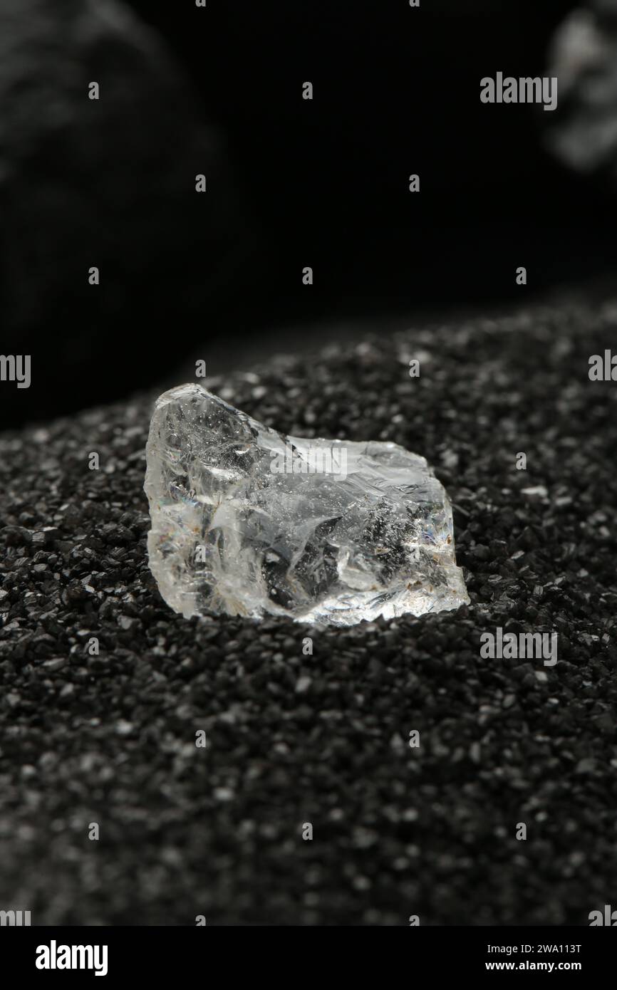 Shiny rough diamond on decorative black sand Stock Photo - Alamy