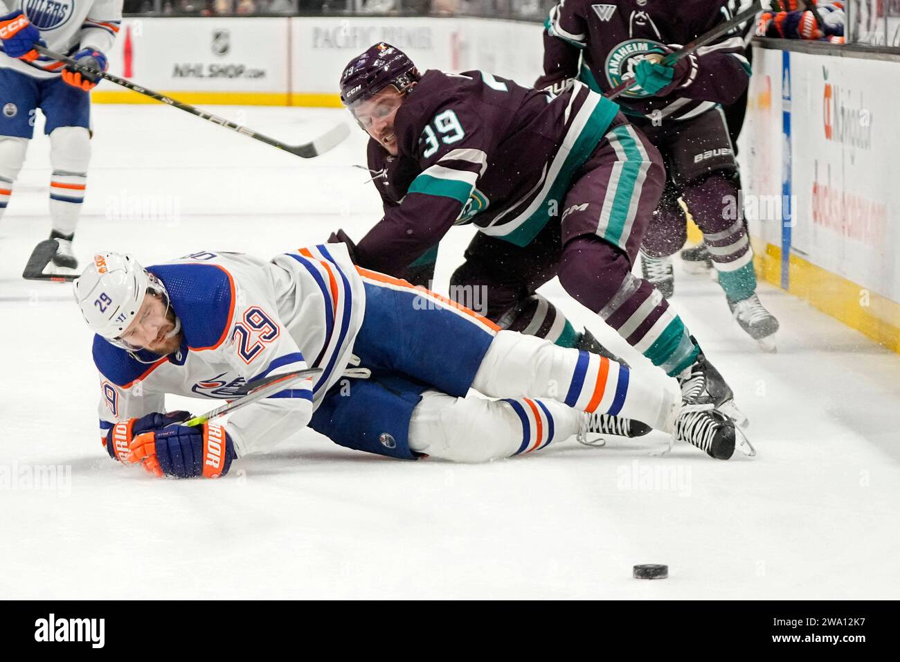 Edmonton Oilers center Leon Draisaitl, left, falls while under pressure ...