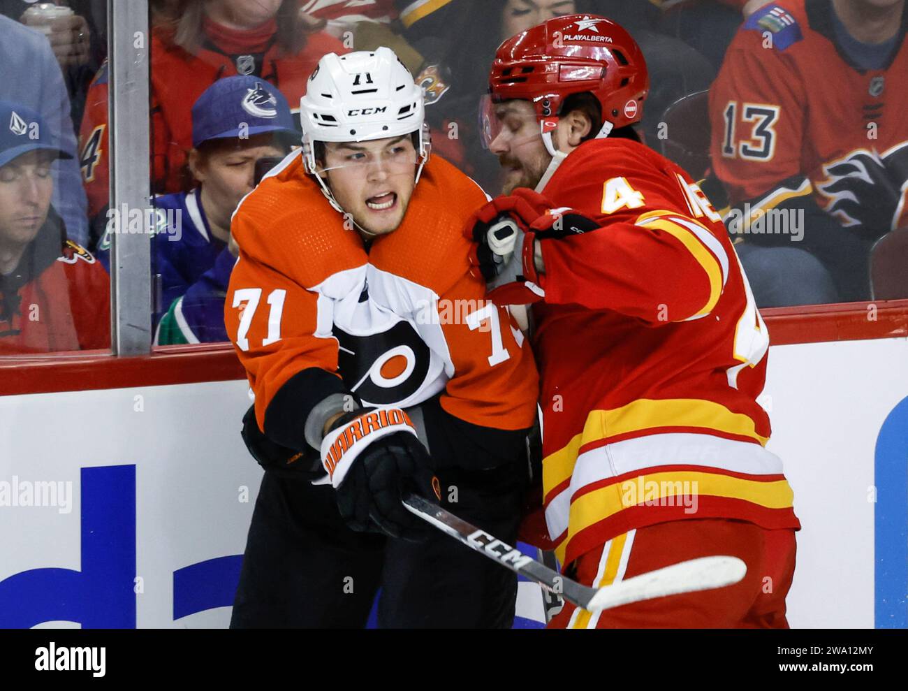 Philadelphia Flyers forward Tyson Foerster, left, is checked by Calgary ...