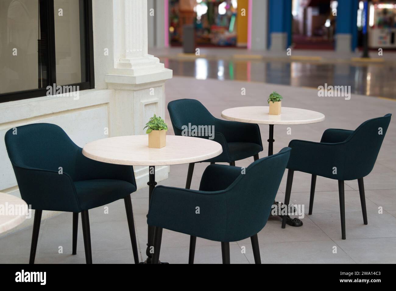 A background image of an empty interior with round tables and cozy ...