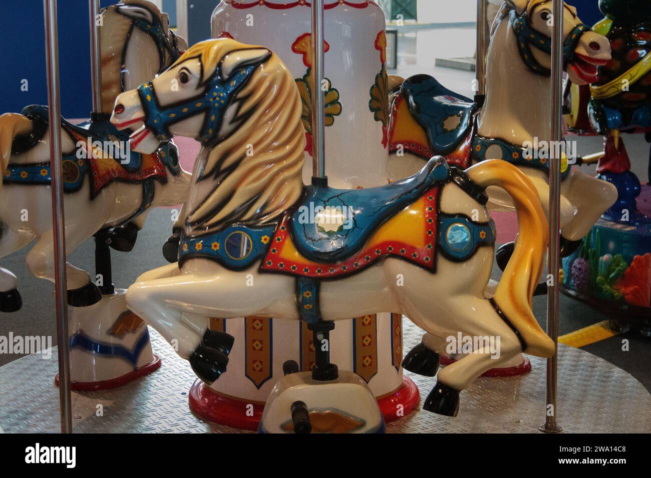 Old children's carousel with a horse close-up. Flying toy animals in ...