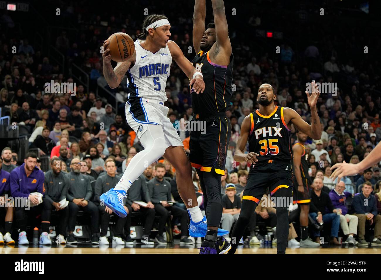 Orlando Magic forward Paolo Banchero (5) looks to pass the ball around Phoenix Suns center Udoka ...
