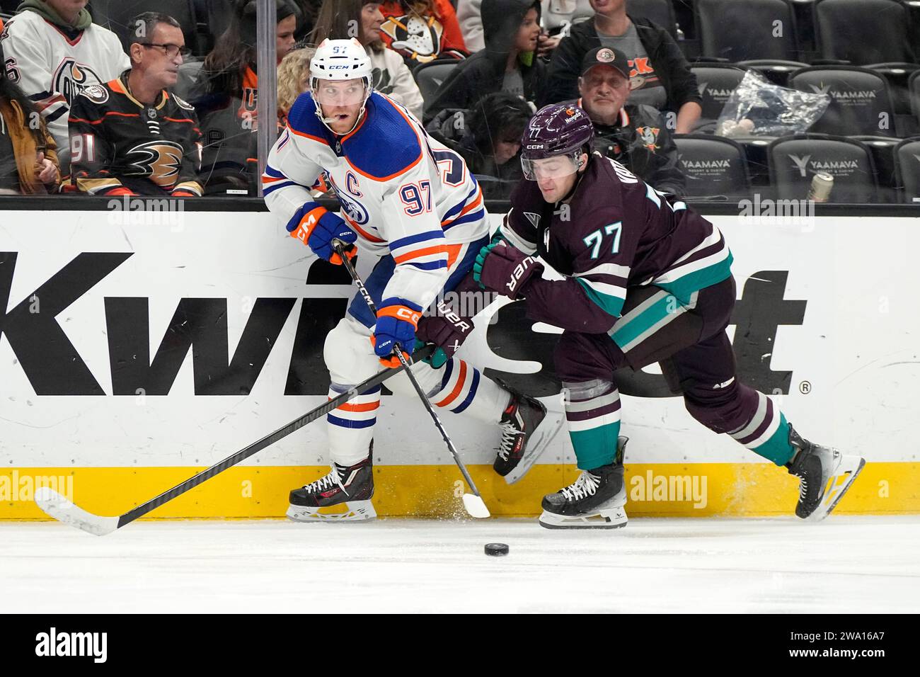 Edmonton Oilers center Connor McDavid, left, passes the puck while ...