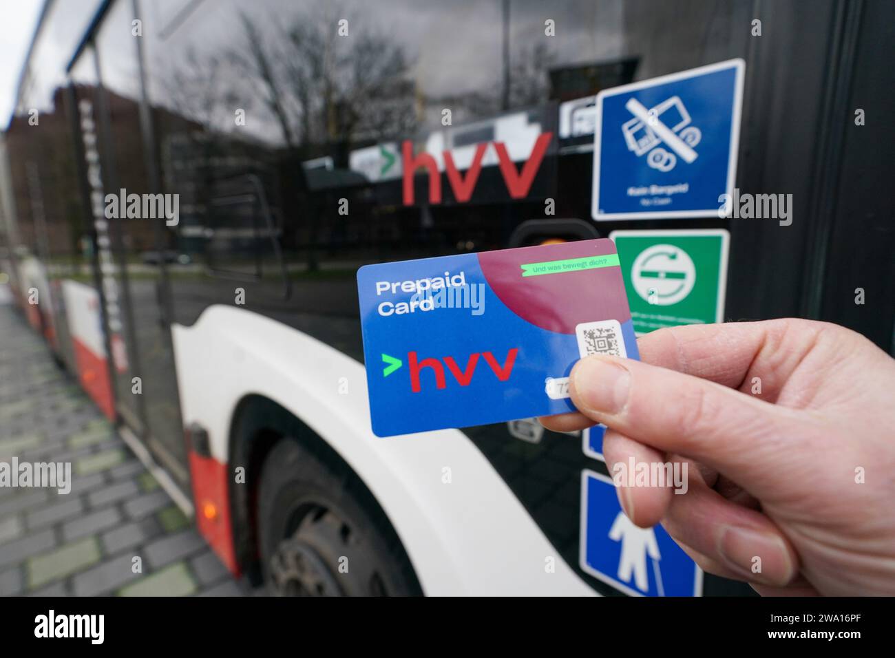 Hamburg, Germany. 28th Dec, 2023. A man holds up a prepaid card for ...