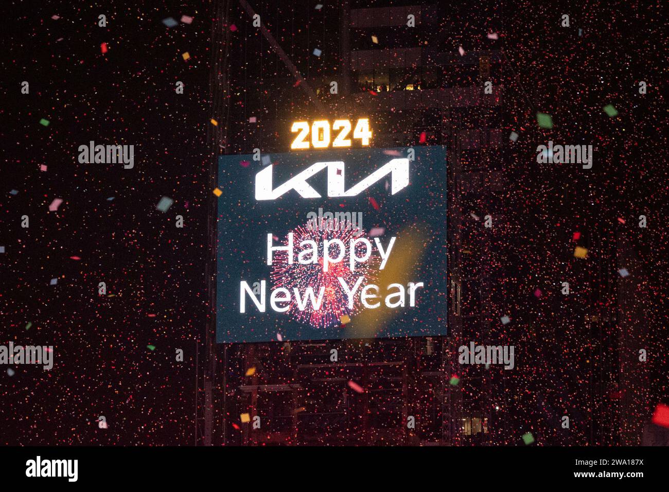 Confetti drops over the crowd as the clock strikes midnight as seen ...