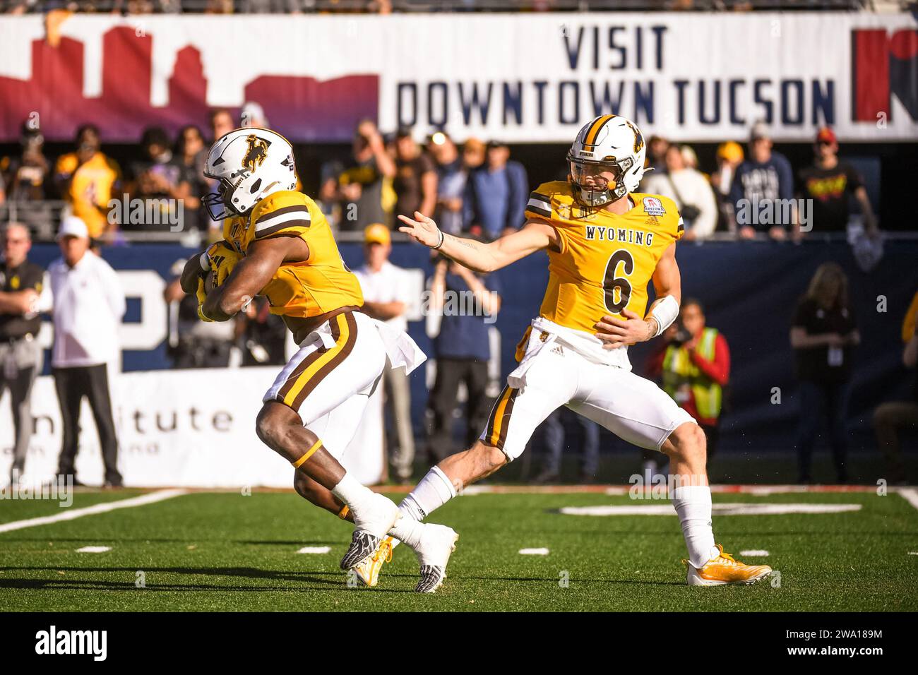 Wyoming Cowboys quarterback Andrew Peasley (6) hands off to running ... Wyoming Cowboys quarterback Andrew Peasley (6) hands off to running ...