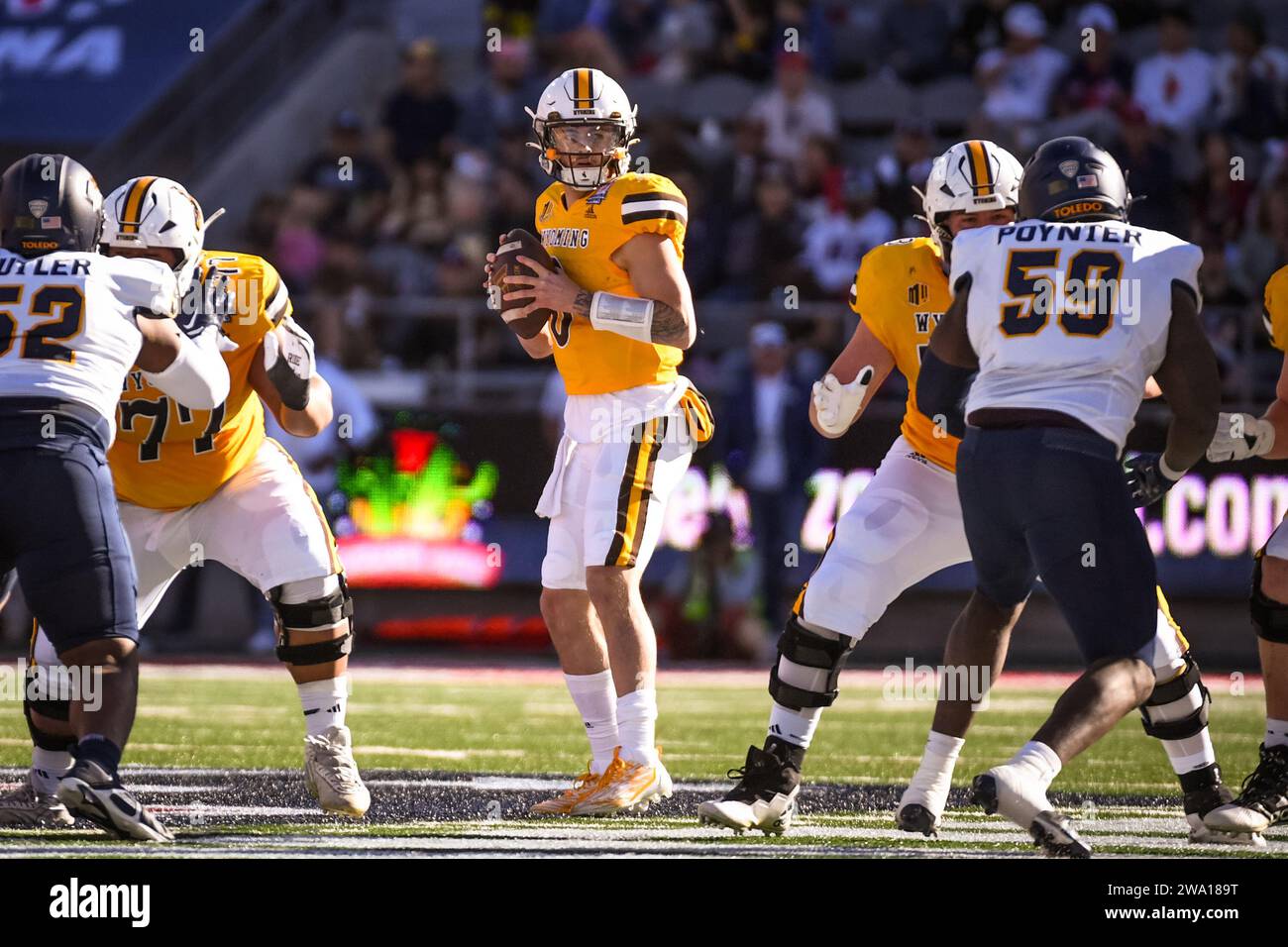 Wyoming Cowboys quarterback Andrew Peasley (6) looks down field in the ...