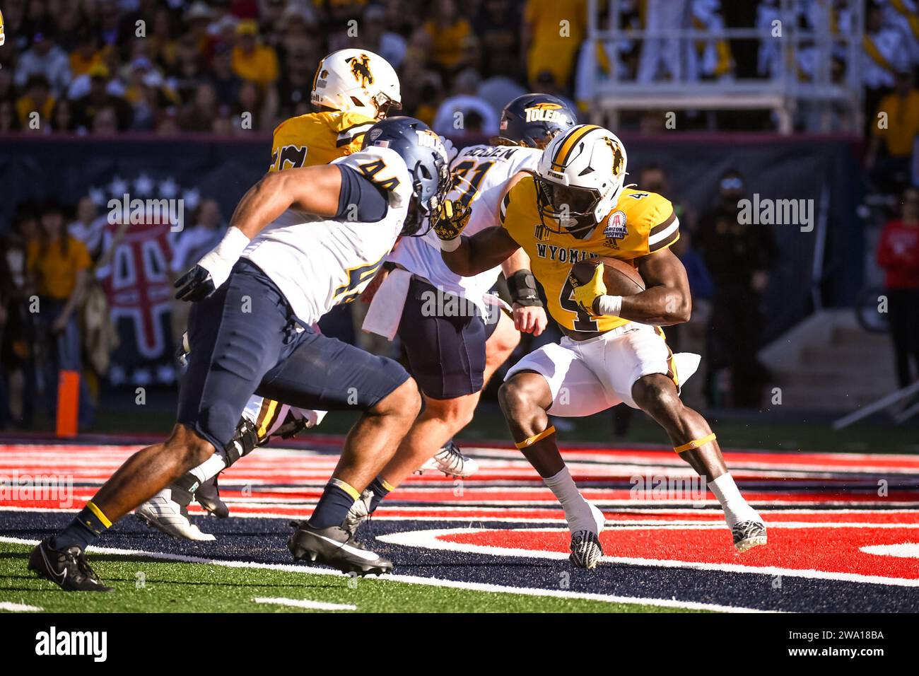 Wyoming Cowboys running back Harrison Waylee (4) runs the ball in the ... Wyoming Cowboys running back Harrison Waylee (4) runs the ball in the ...