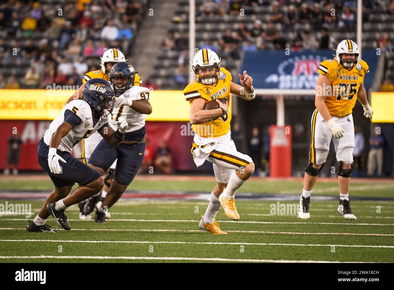 Wyoming Cowboys quarterback Andrew Peasley (6) runs for a first down in ...