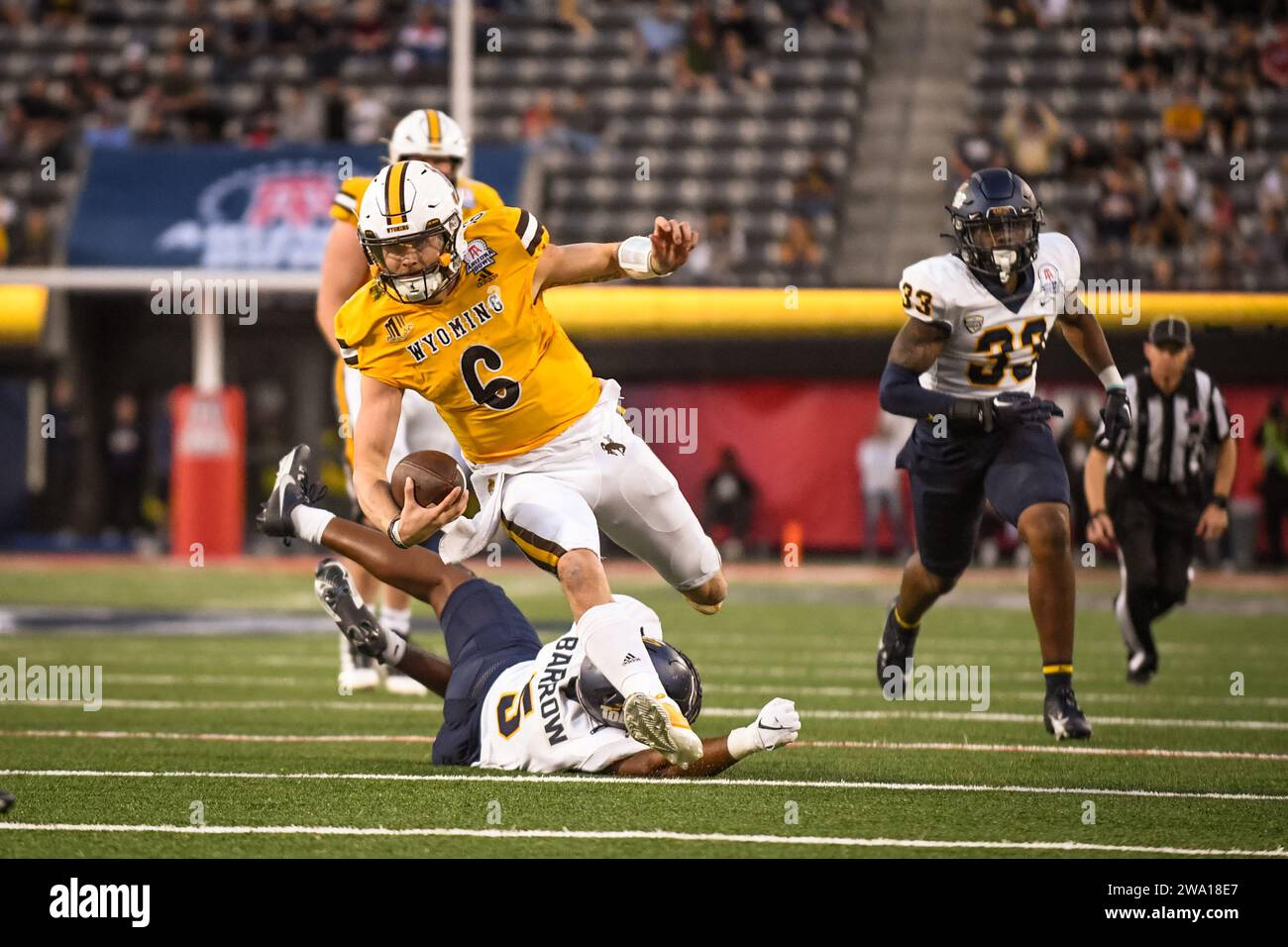 Wyoming Cowboys quarterback Andrew Peasley (6) runs for a first down in ...