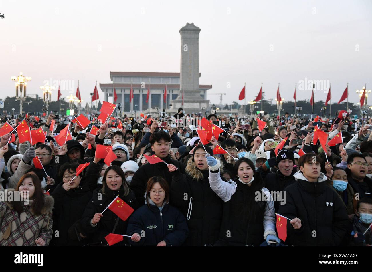 Beijing, China. 1st Jan, 2024. People hail after a grand national flag ...