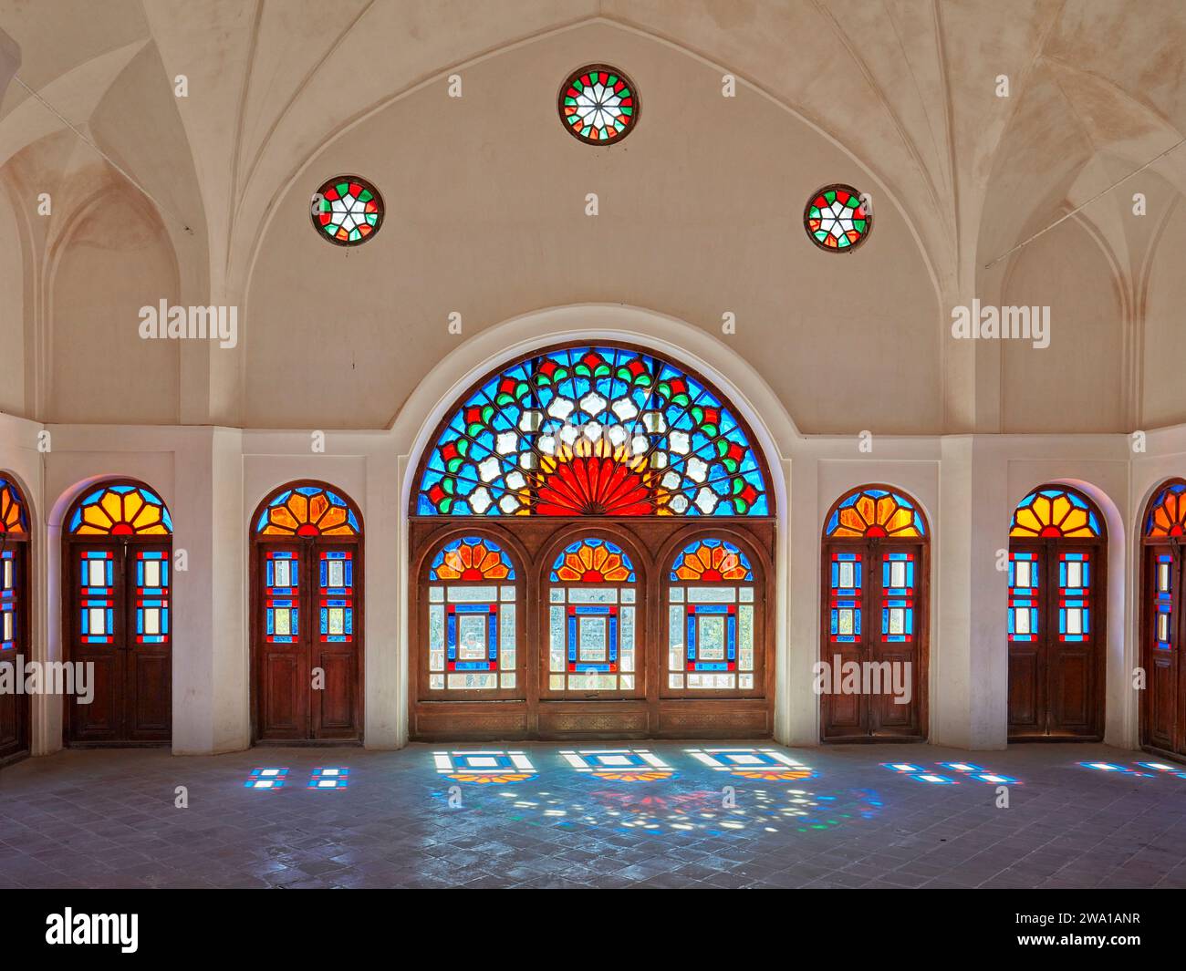 Large room with colorful stained glass windows in the Tabatabaei House ...