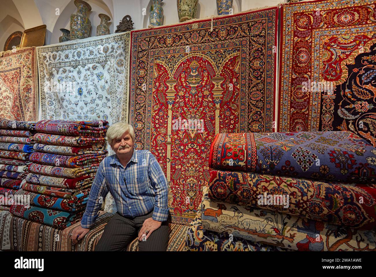 Iranian carpet seller in his shop in the Aminoddole Caravanserai ...