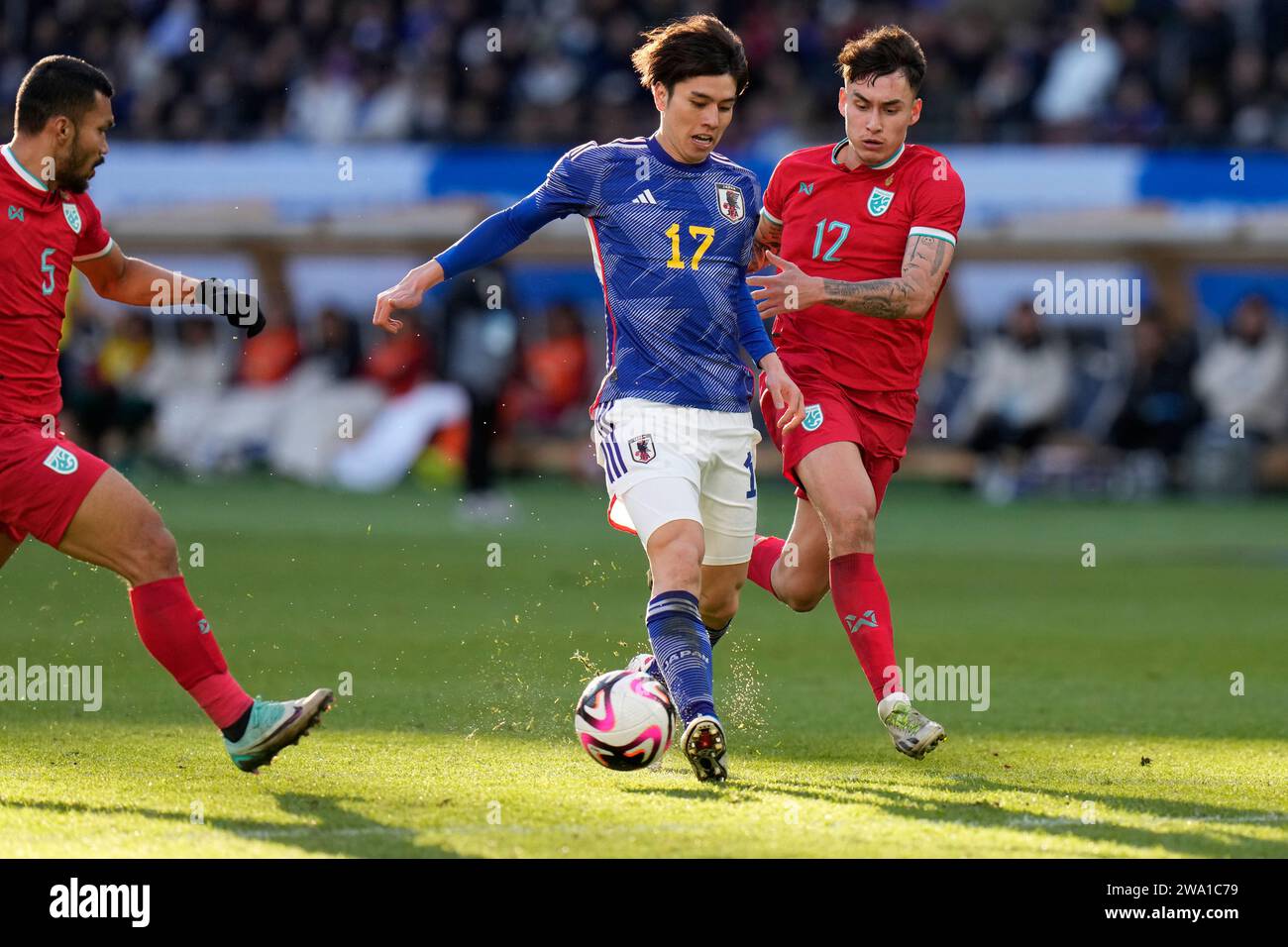 Ao Tanaka, center, of Japan, tries to score a goal against Look Saa ...