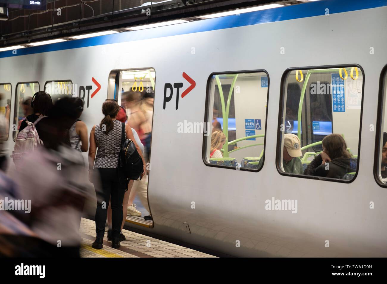 Commuters board the newly arrived train at a station of the Melbourne ...