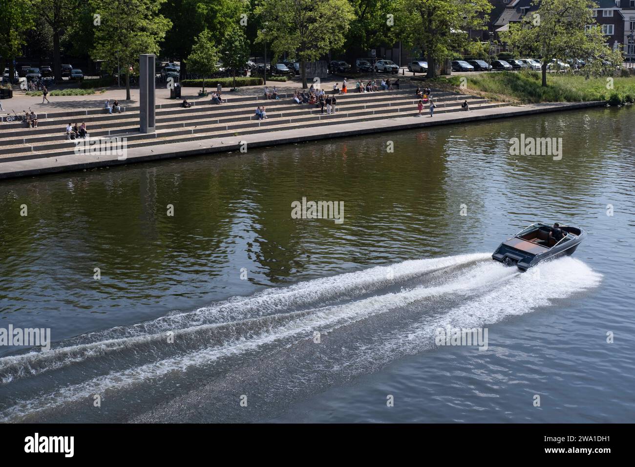 Speedboat sails over the river Maas along the 'Maastrappen' next to the ...