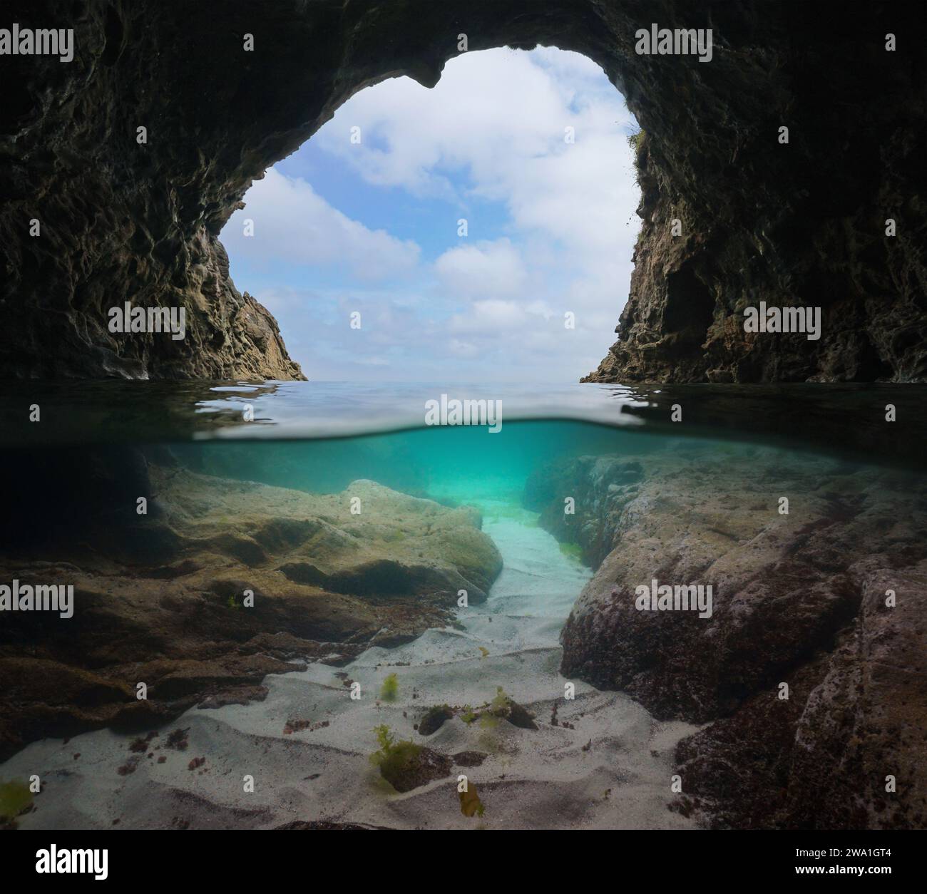 Inside a sea cave on the Atlantic coast of Spain, split view half over ...