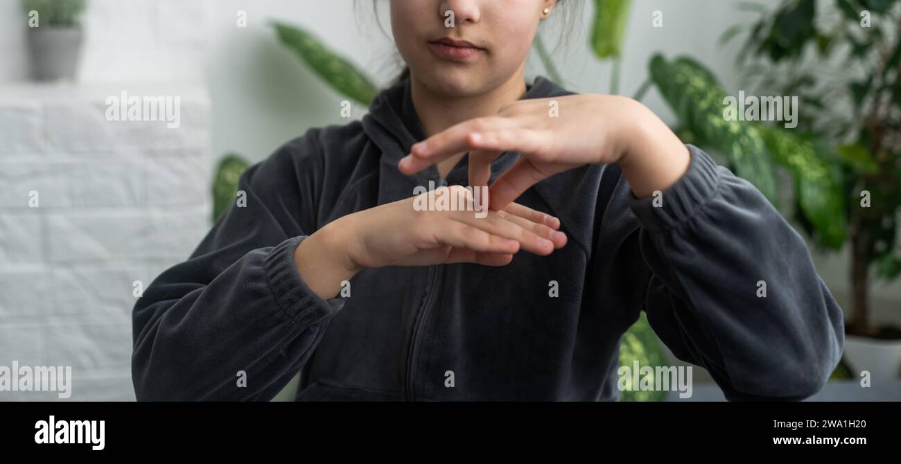 Beautiful smiling deaf girl using sign language Stock Photo - Alamy