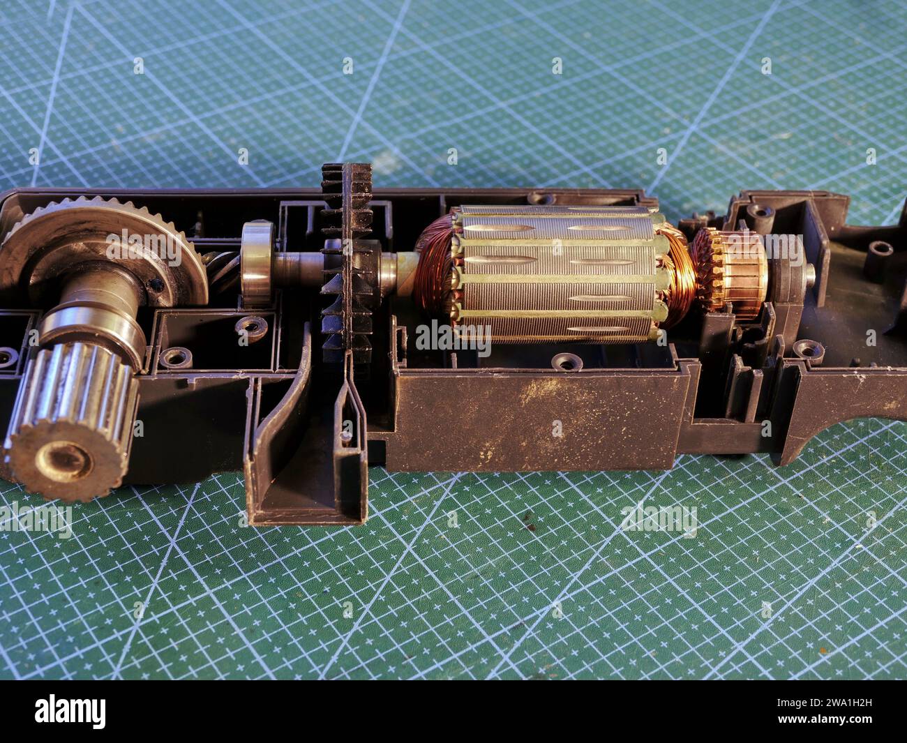 disassembled power tool, electric motor rotor, mechanical gearbox gears ...