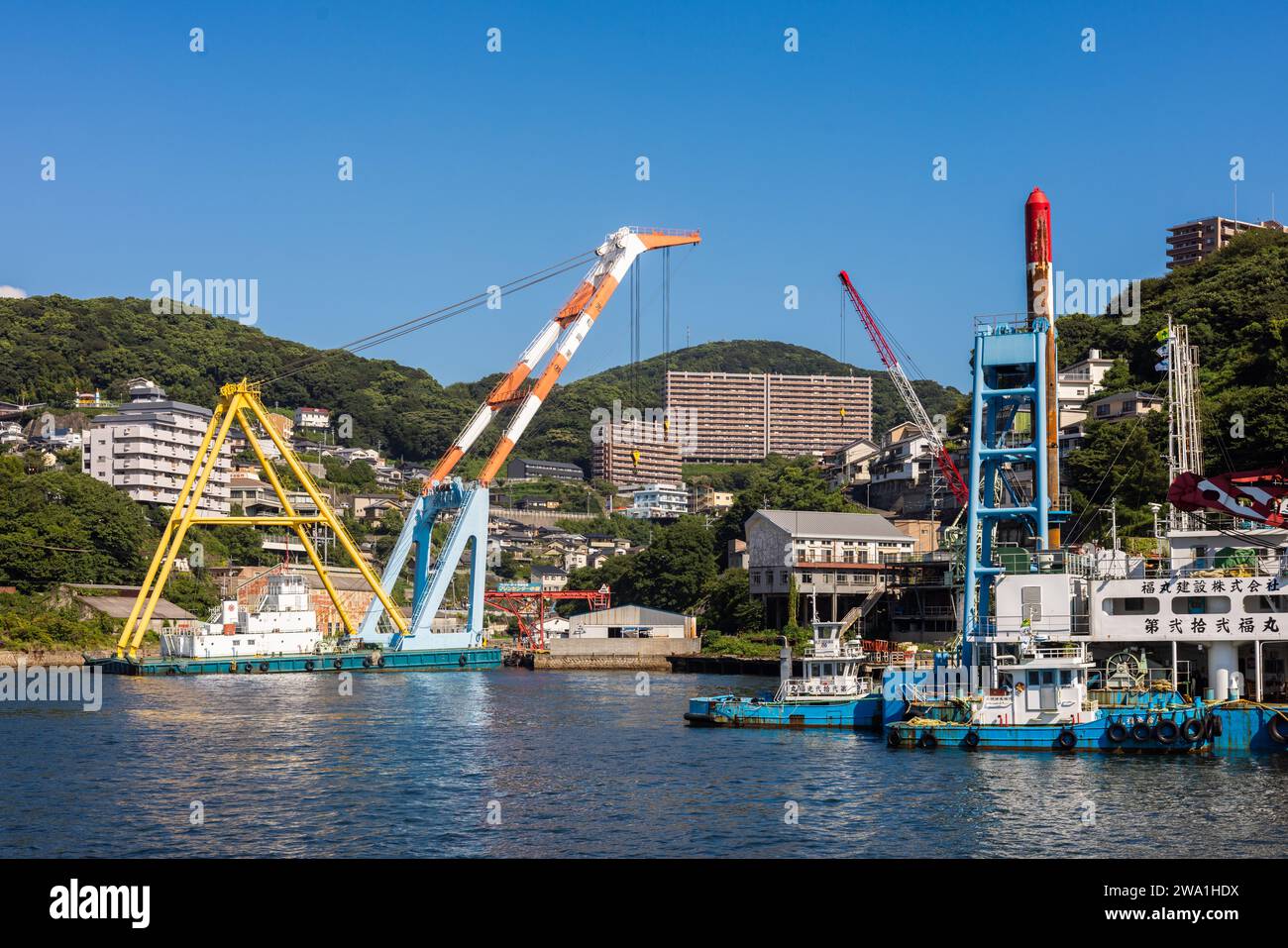Shipyards within Nagasaki bay Japan, industrial landscape shore harbour ...