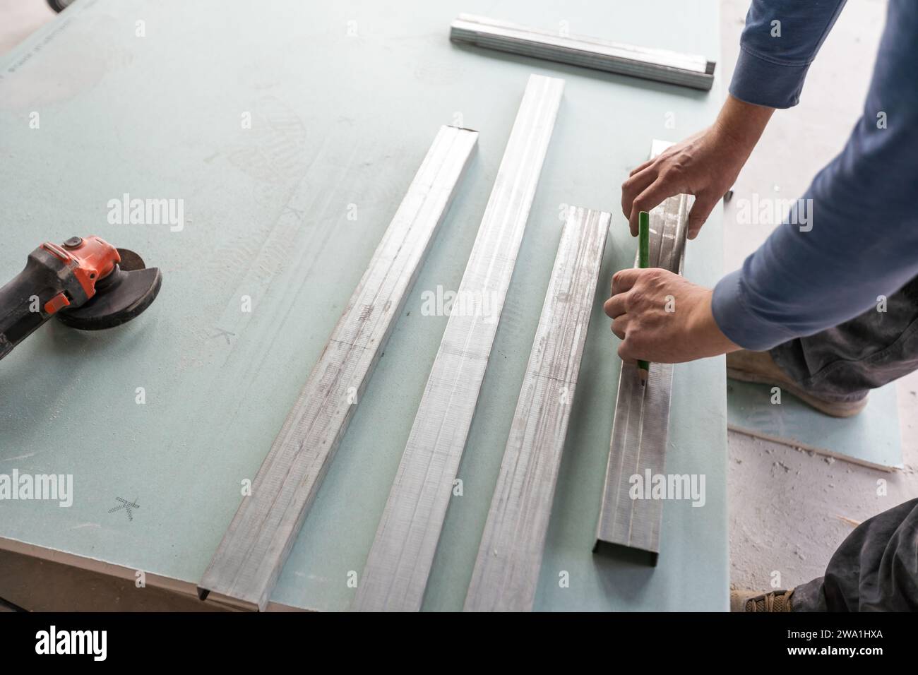 Workers fitting panel into frame of ceiling Stock Photo - Alamy