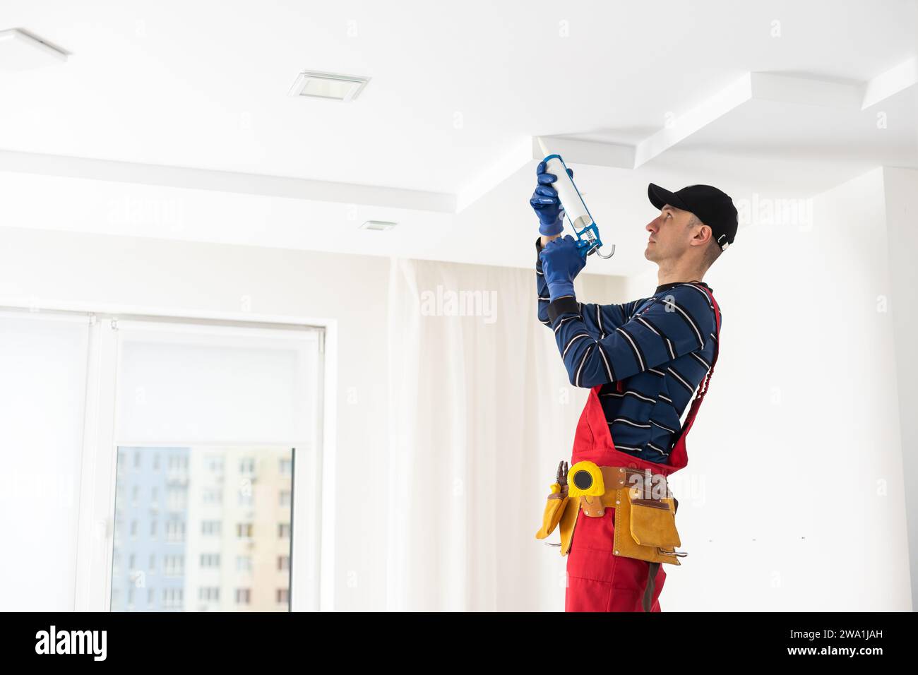 Construction worker installation ceiling work Stock Photo - Alamy