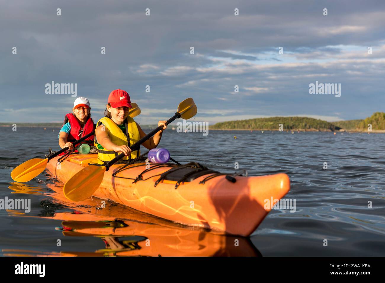 A woman and her daughter sea kayaking in Frenchman Bay, Acadia National ...