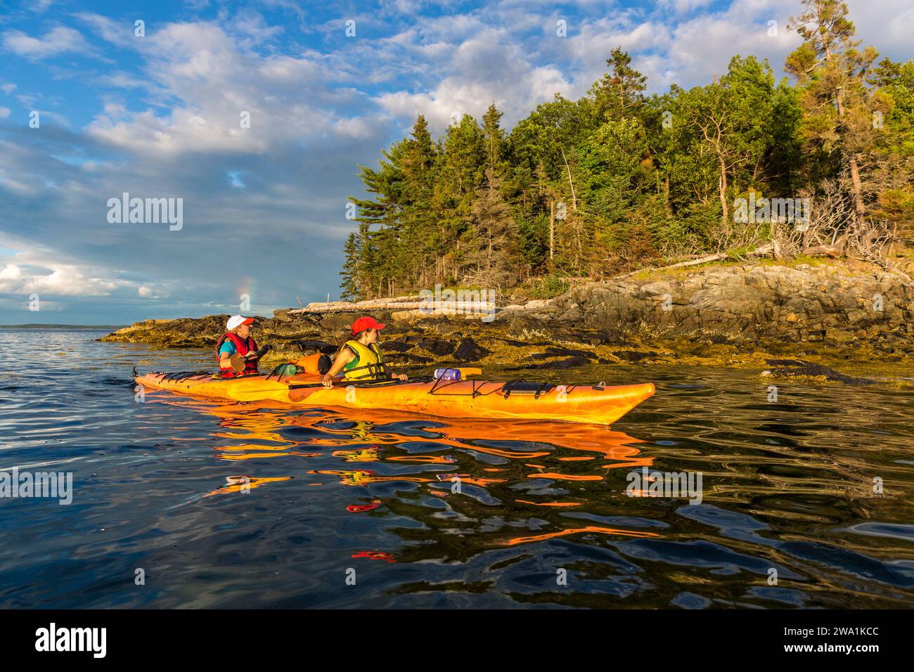 A woman and her daughter sea kayaking in Frenchman Bay, Acadia National ...