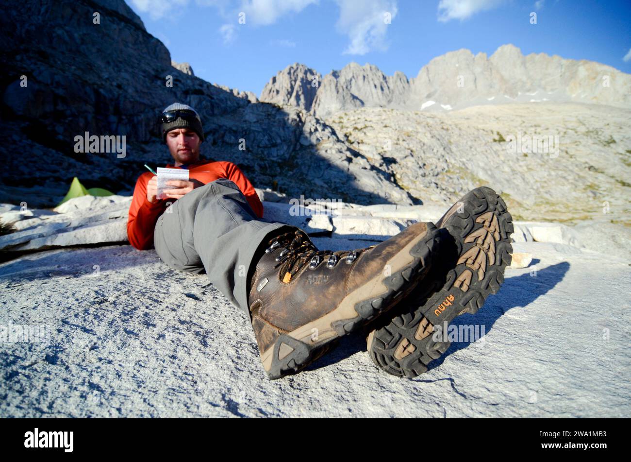 A man writes in his journal below the Palisade Crest near Cirque Pass ...