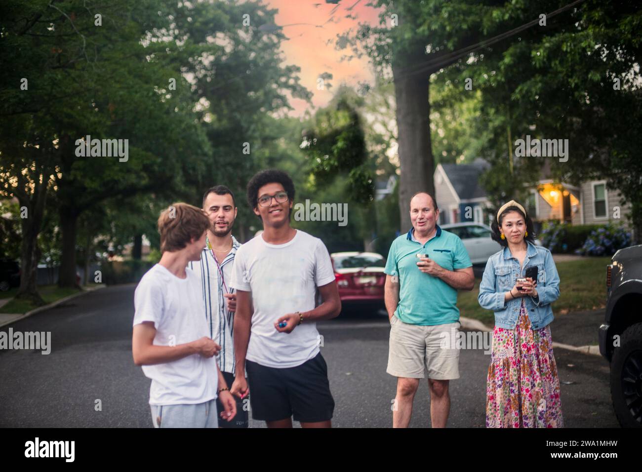 Neighbors getting together on holiday block party Stock Photo - Alamy