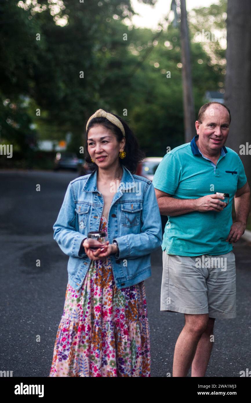 Neighbors getting together on holiday block party Stock Photo - Alamy